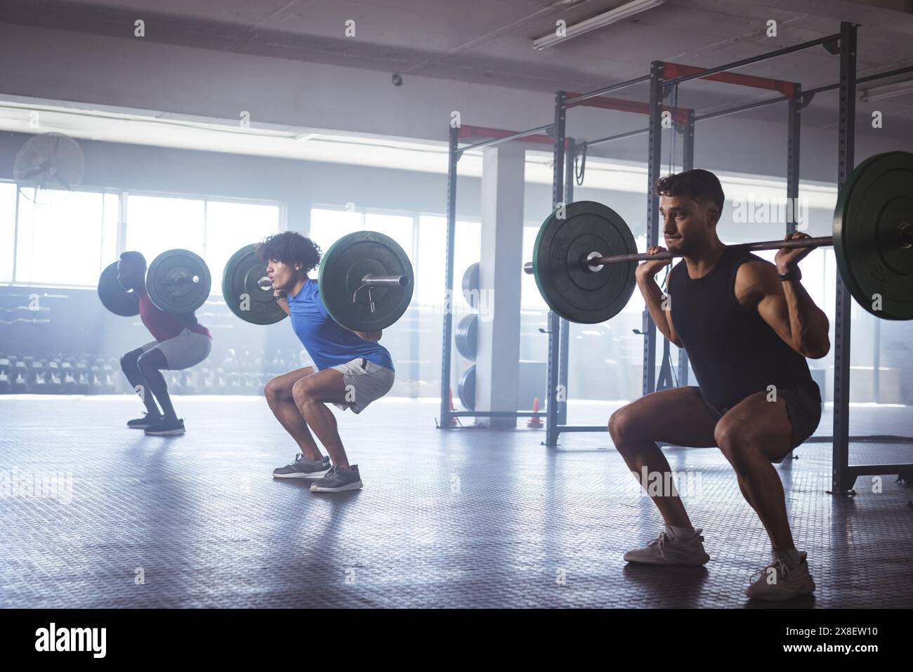 At gym, three young diverse men, African American and two Biracial ...