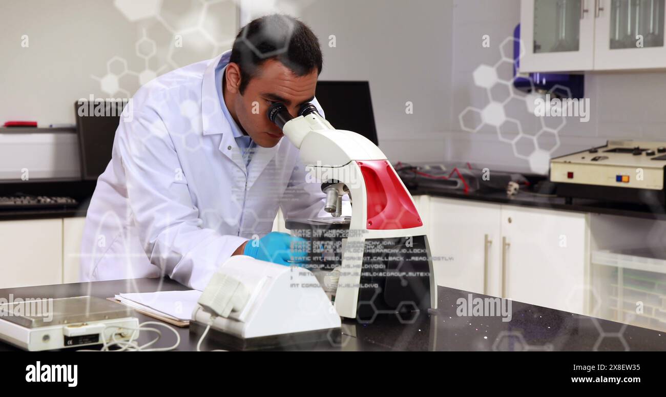 Middle-aged Caucasian man wearing lab coat, examining samples under ...