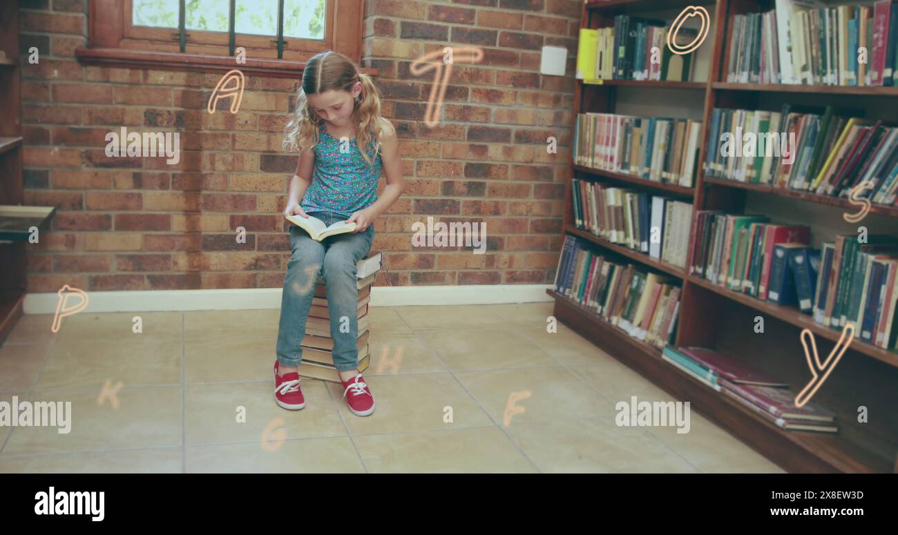 Caucasian girl wearing blue top and jeans, reading in school library ...