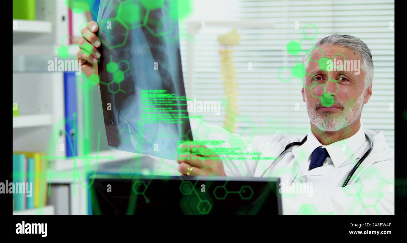 Caucasian male doctor, wearing white coat, examining X-ray, using ...