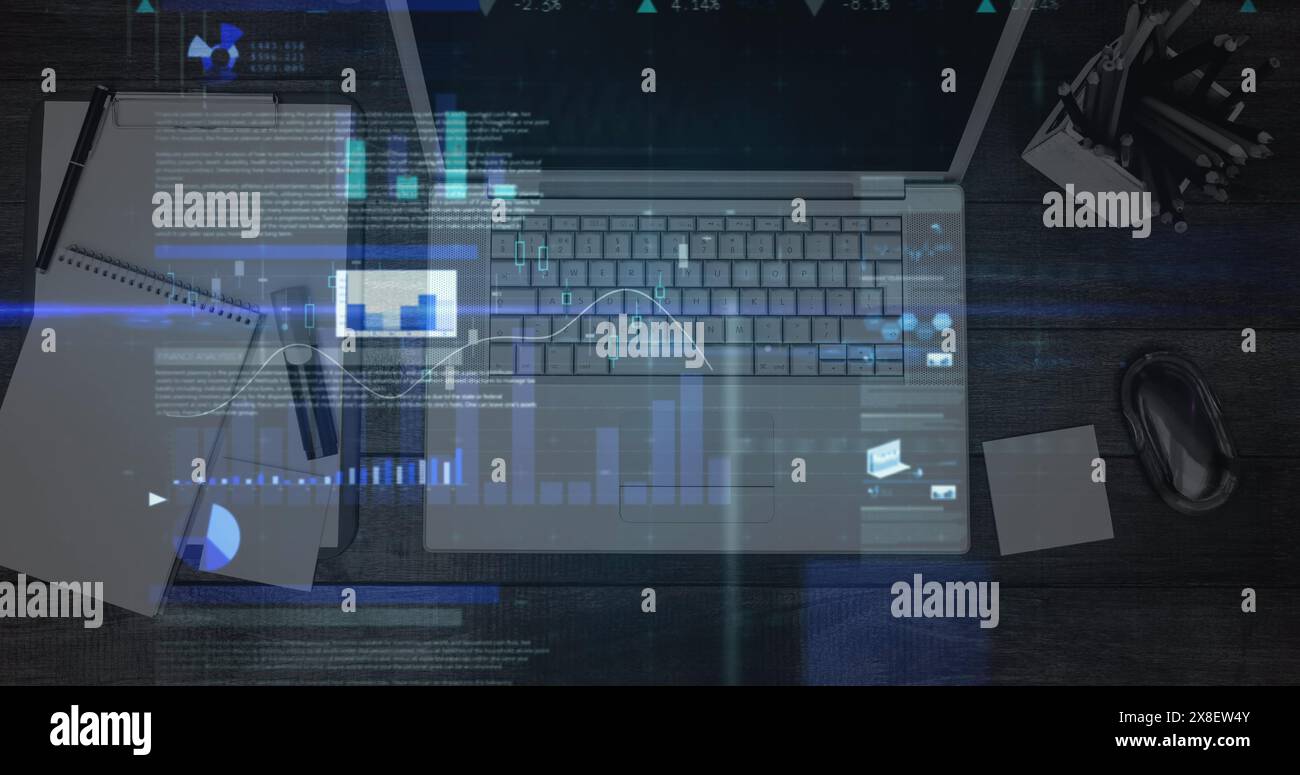 Laptop showing graphs and code overlays on dark desk Stock Photo - Alamy
