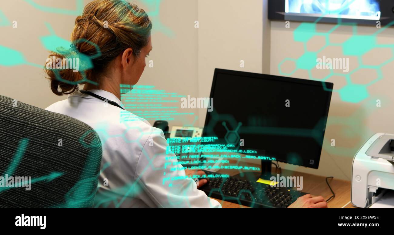 Caucasian woman wearing lab coat sitting, examining data on computer ...