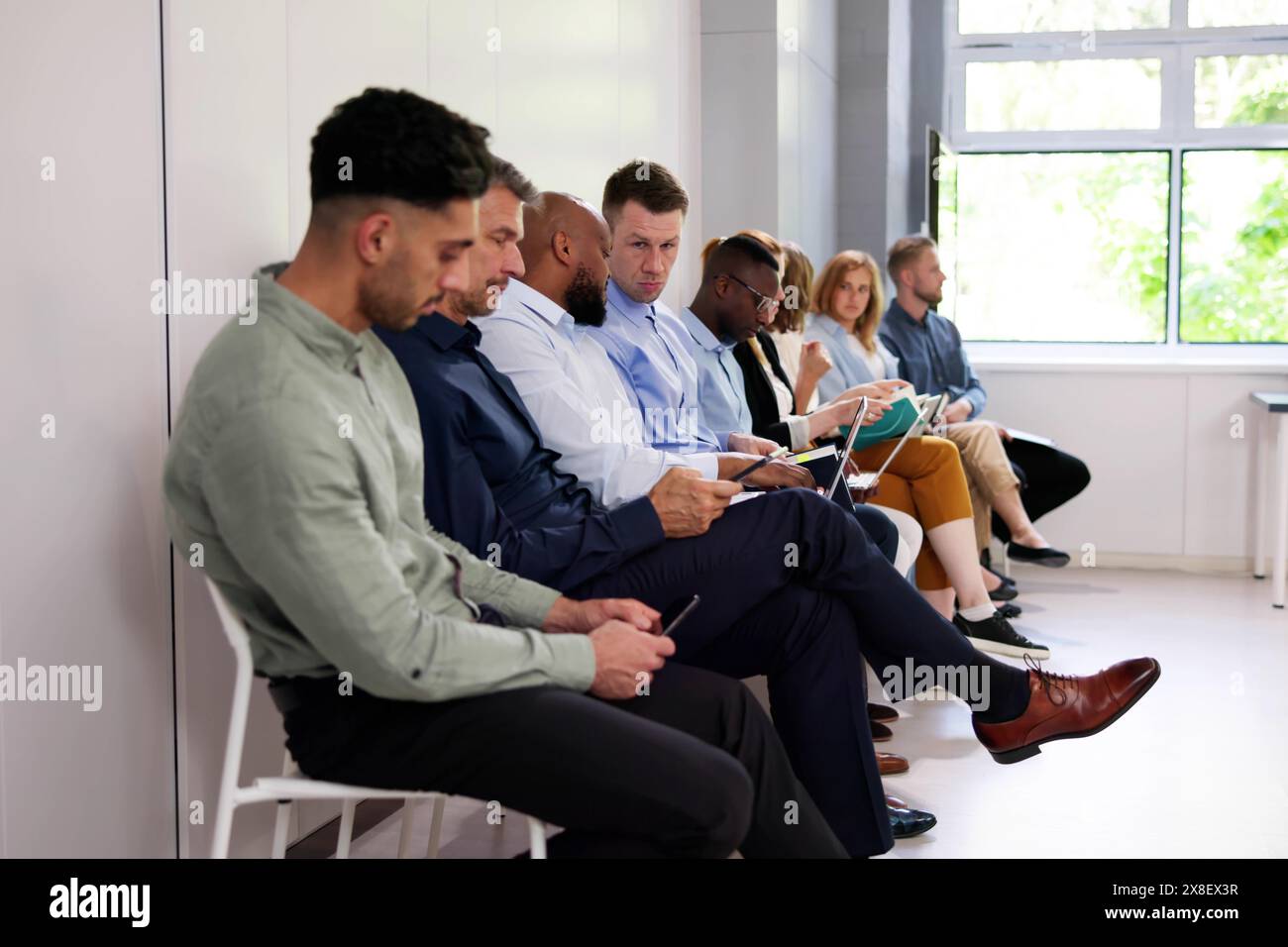 Row Of Diverse People Waiting For Job Interview In Office Stock Photo ...