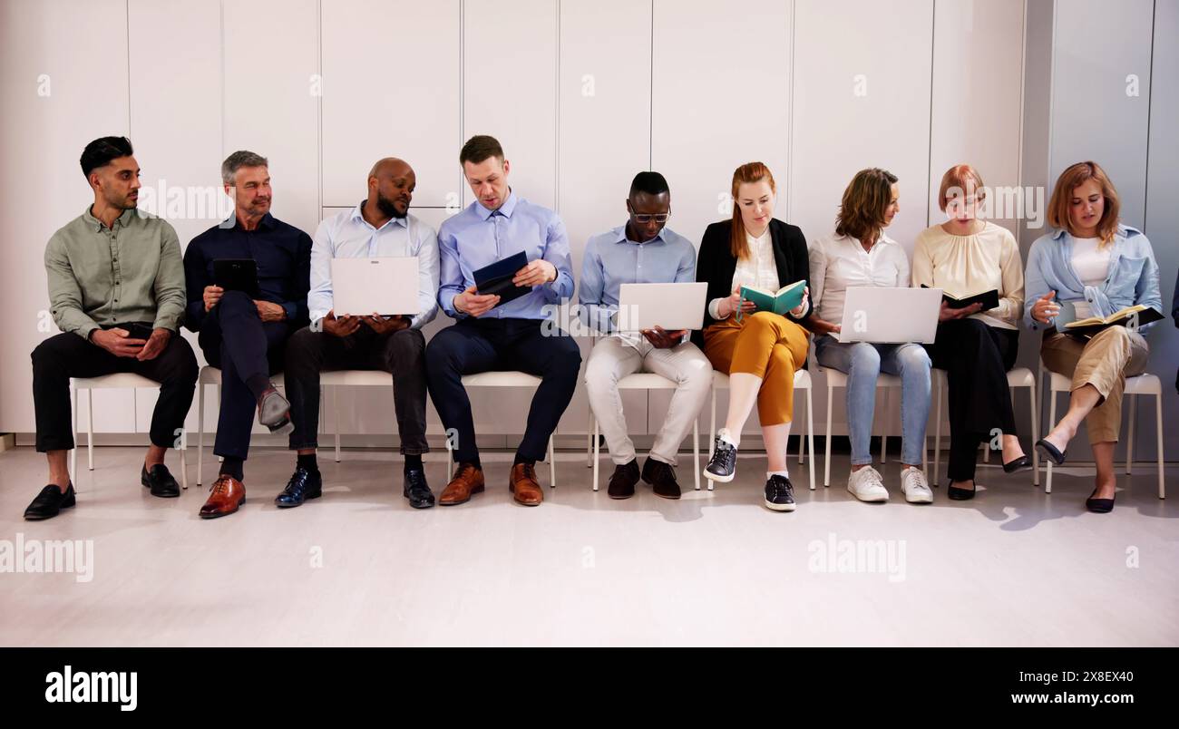 Row Of Diverse People Waiting For Job Interview In Office Stock Photo ...