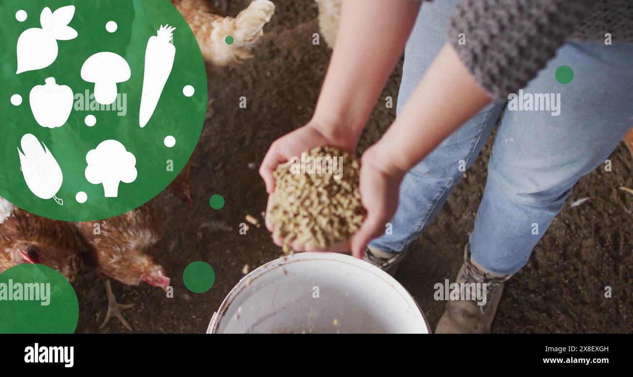 Image of vegetable icons and spots over mid section of woman feeding ...