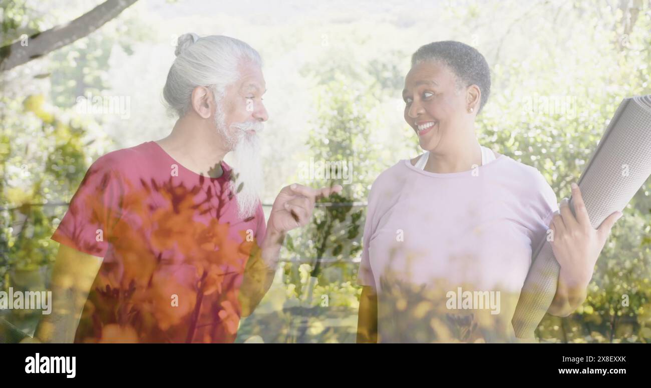 Image of spots of light and trees over diverse senior people talking in ...