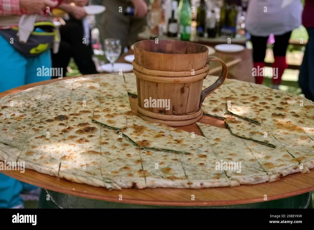 Soparnik - traditional Croatian food on big wooden plate with wooden ...