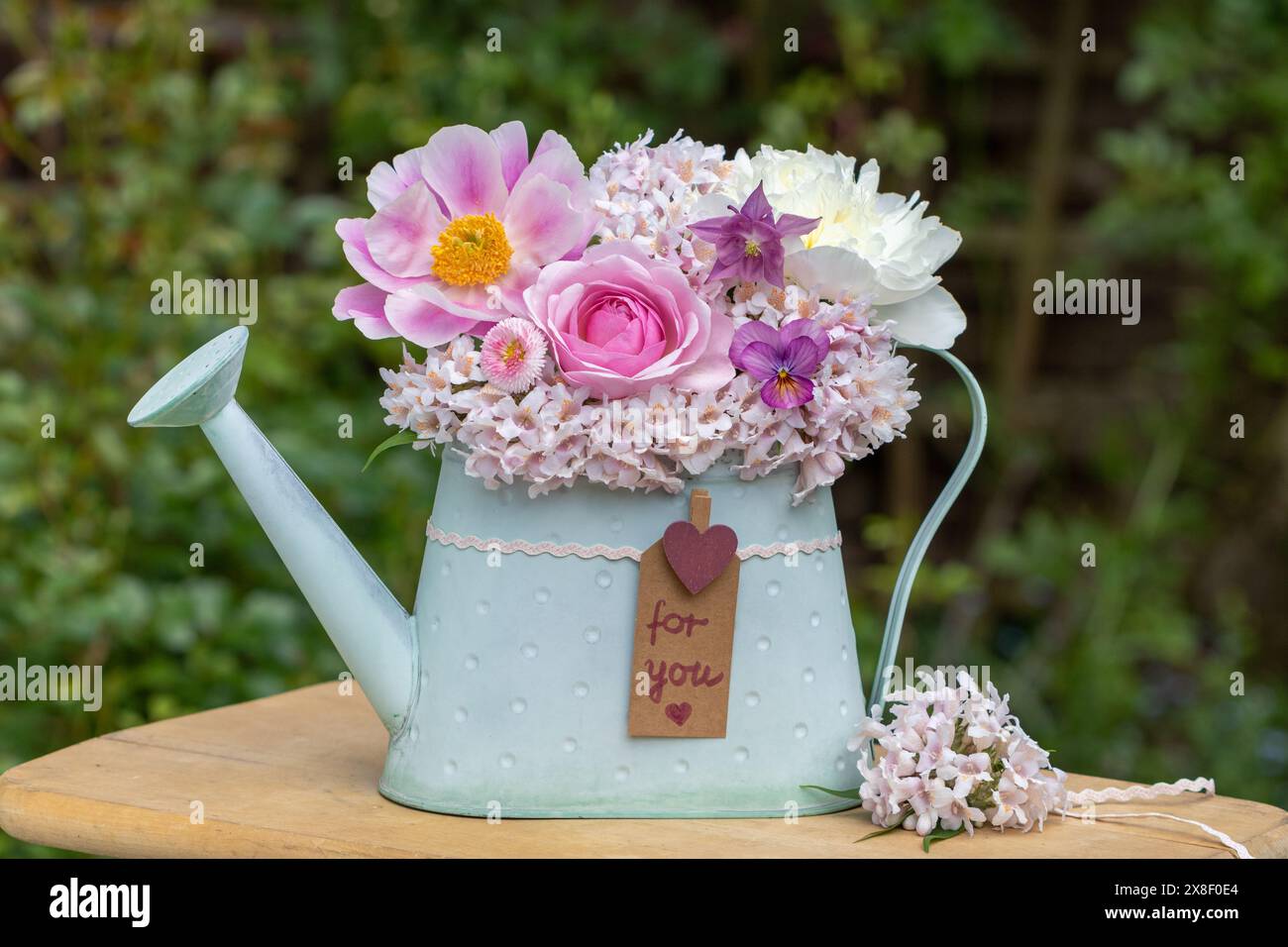 romantic flower arrangement with pink rosem peony flowers, viola flower ...