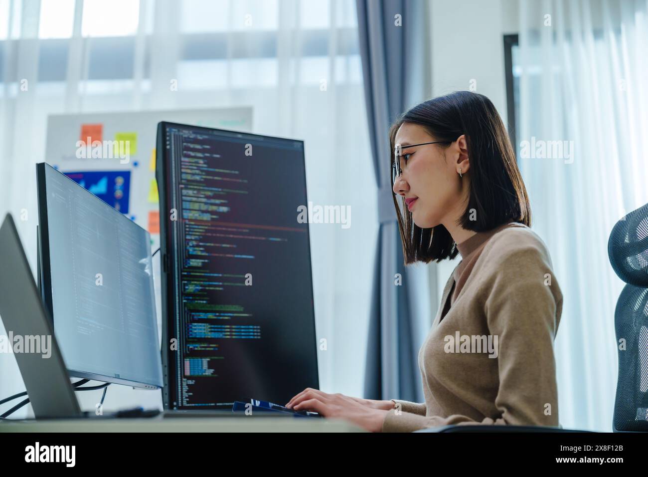 Asian Prompt Engineer Develop Coding App With Software Data Sitting In