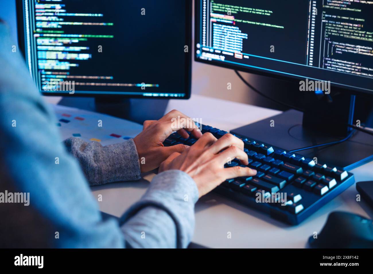 close up hand of Asian prompt engineer develop coding app with software data sitting in front of ...
