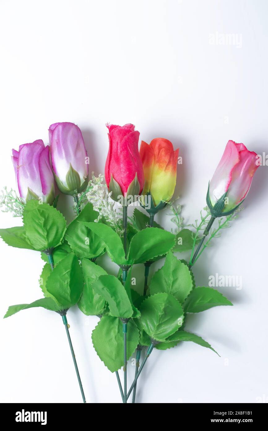 Bouquet of colorful artificial roses on white background with copy ...