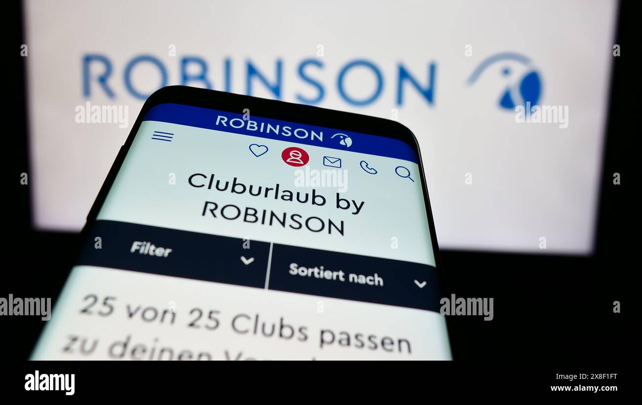 Smartphone with webpage of German hospitality company Robinson Club GmbH in front of business ...