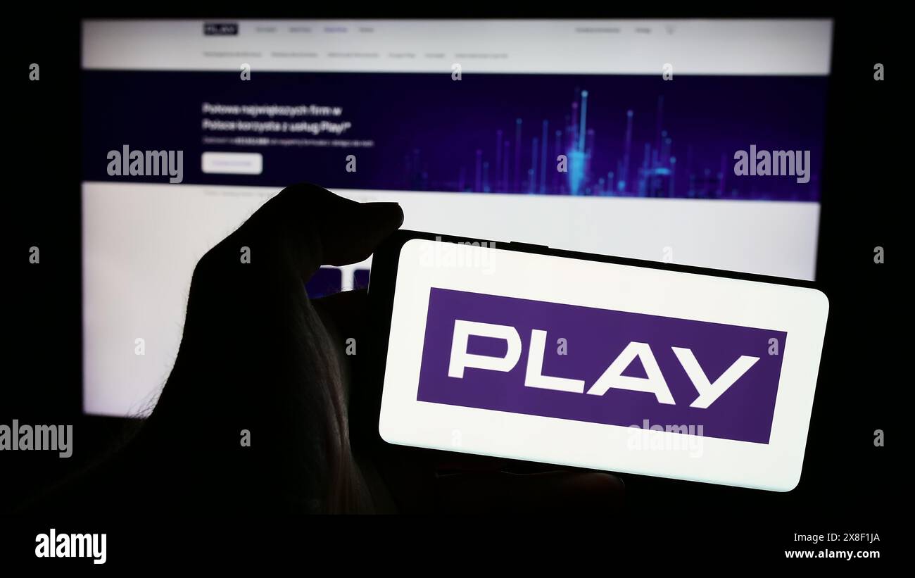 Person holding mobile phone with logo of Polish telecommunications ...