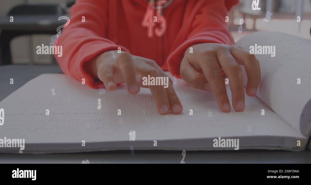 Image of letters and numbers over caucasian schoolboy reading braille ...