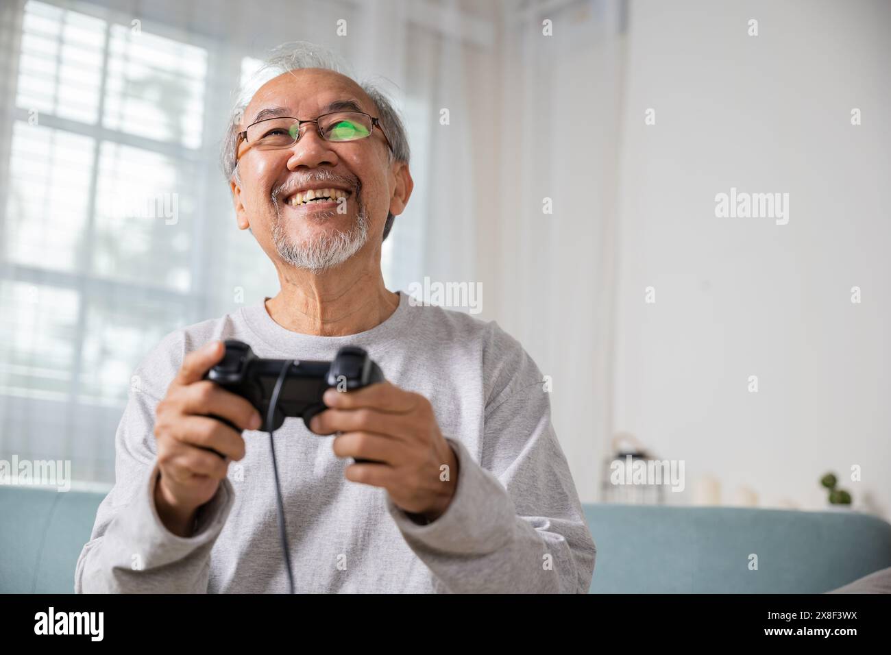 Asian mature man hands using game controller play videogame Stock Photo ...