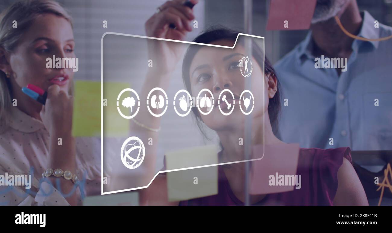 Image of multiple digital icons against diverse colleagues discussing ...