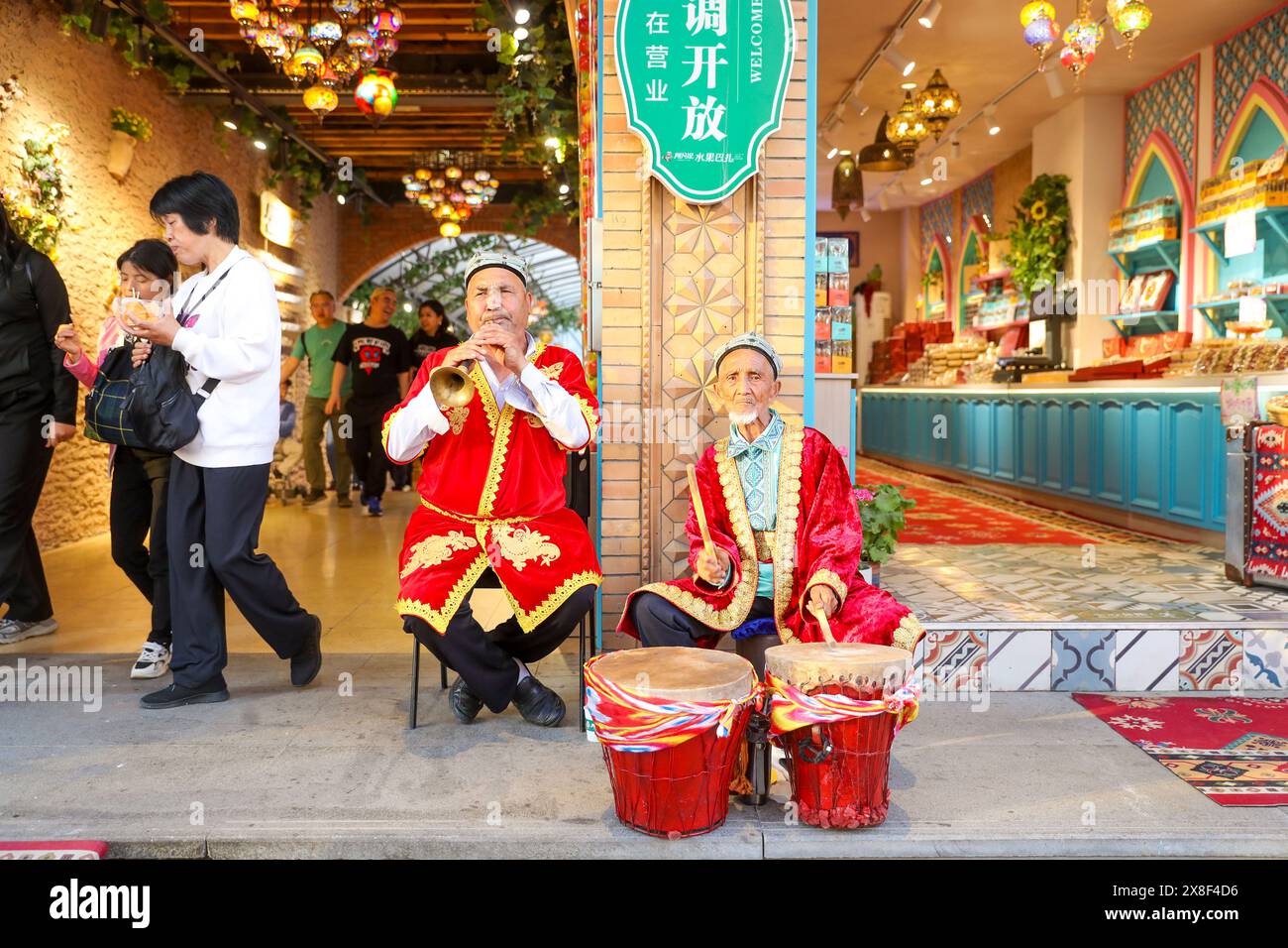 Two elderly people are playing music for visitors at the Xinjiang ...