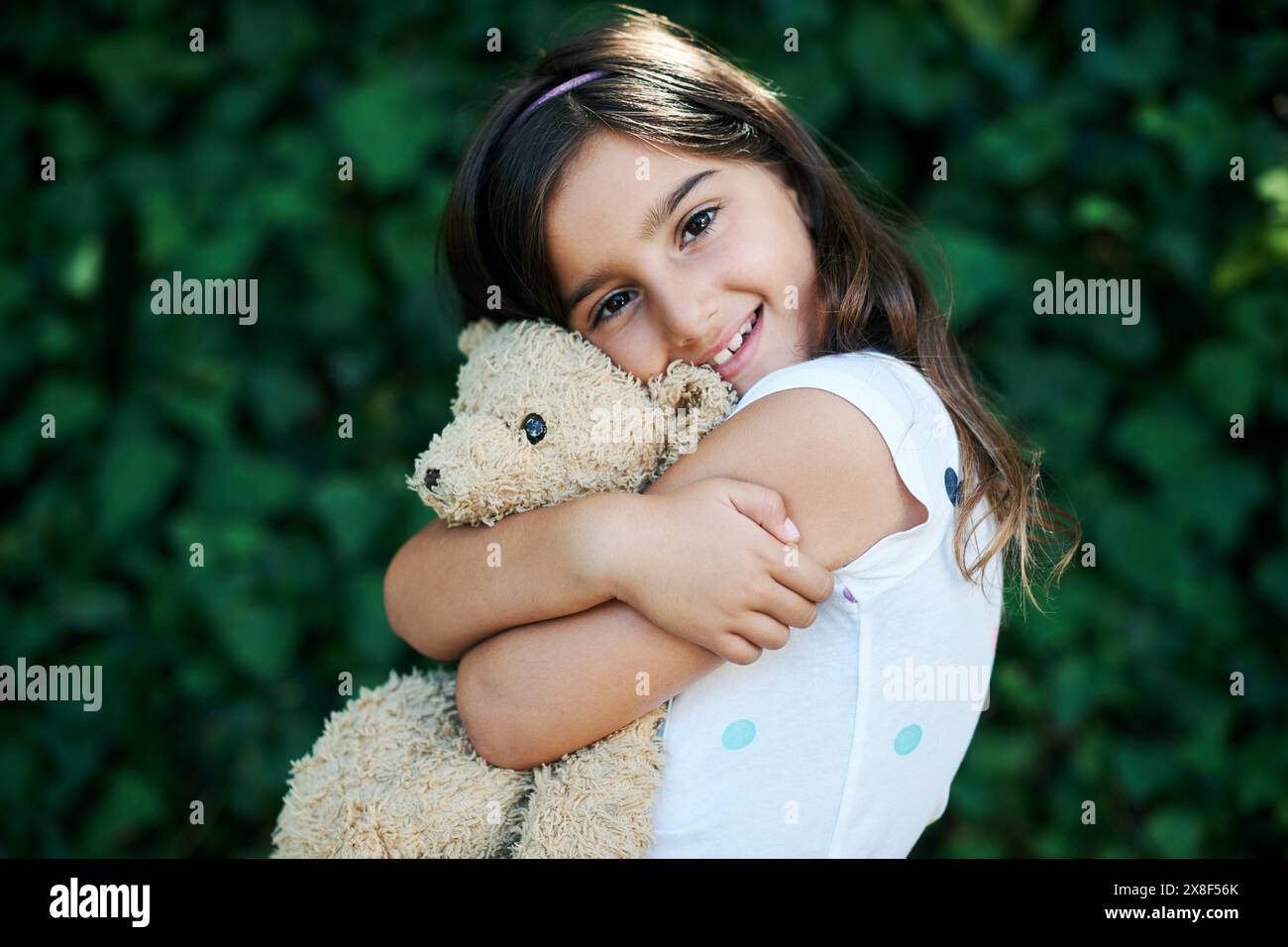 Toys, portrait and girl hug teddy bear outdoor with safety and security ...