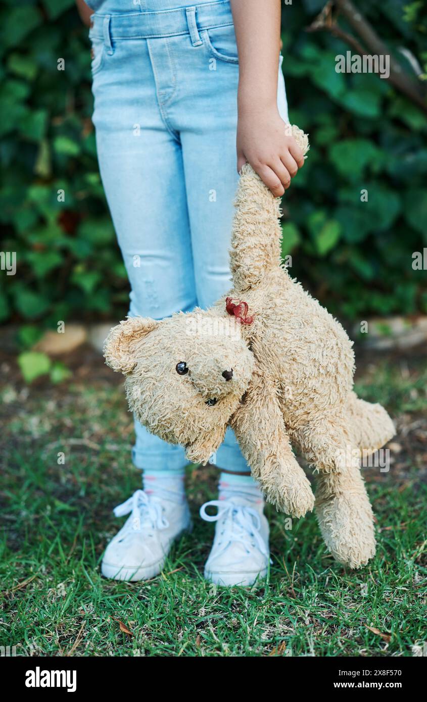 Child, kid and legs and teddy bear or sad in garden park or lost alone ...