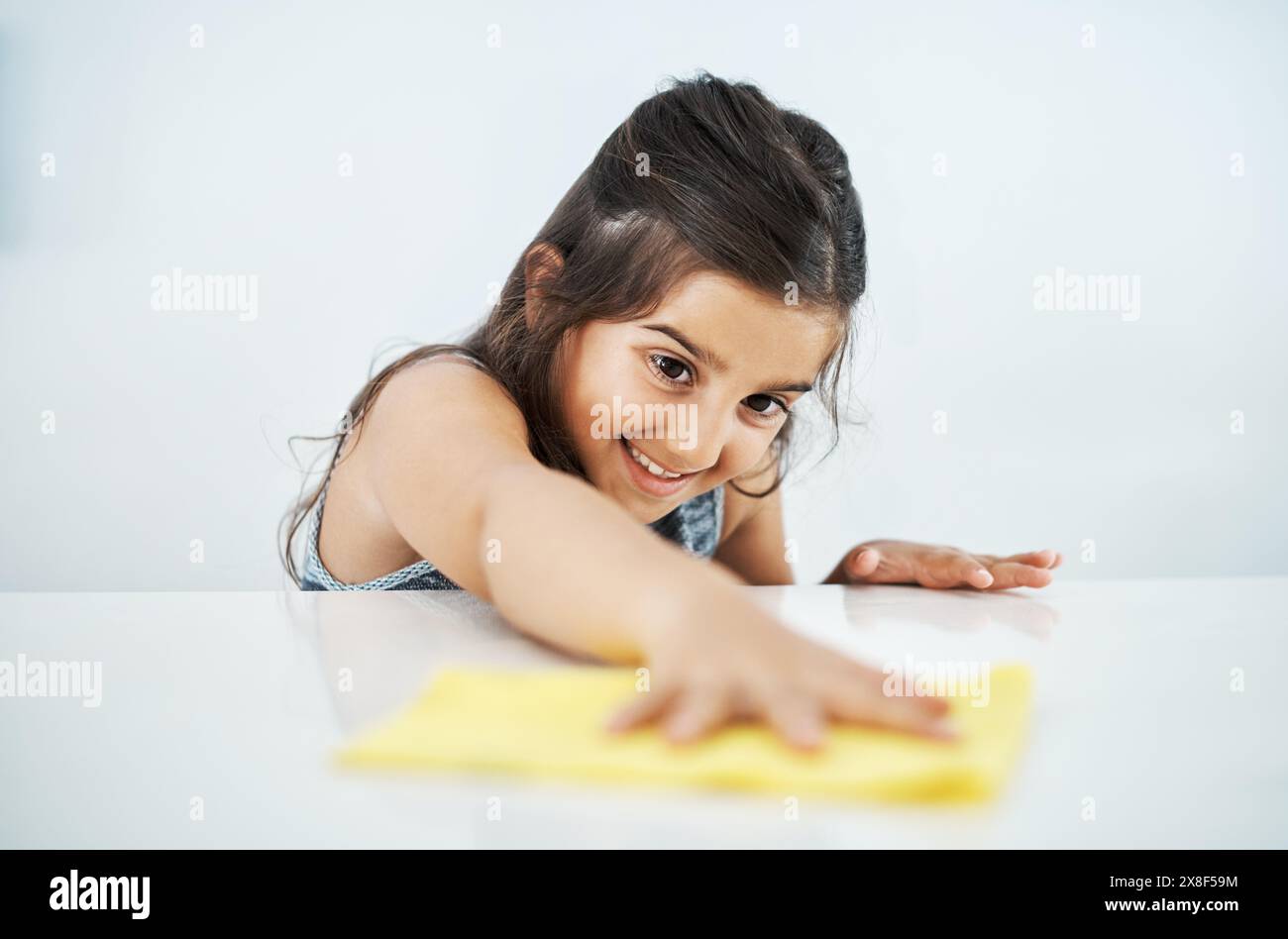 Happy child, cloth and cleaning table in home for hygiene, chores and ...