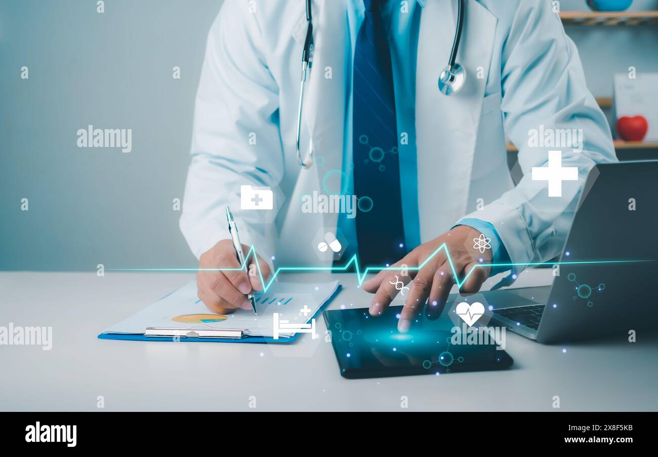 Male doctor using tablet to review treatment plan and write document ...