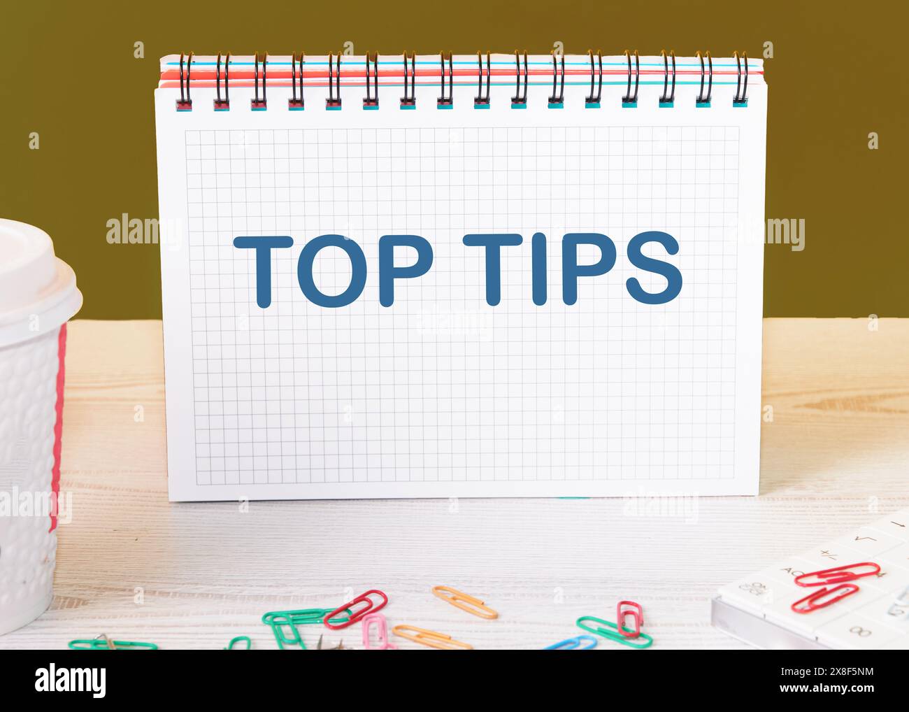 Business concept. Text TOP TIPS on a checkered notebook on the office ...