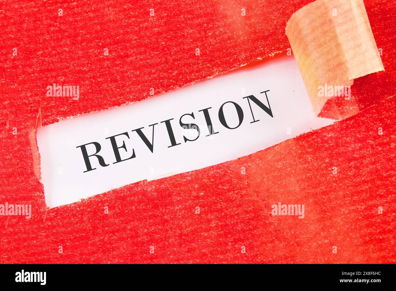 REVISION word written under the torn paper on a white background Stock ...