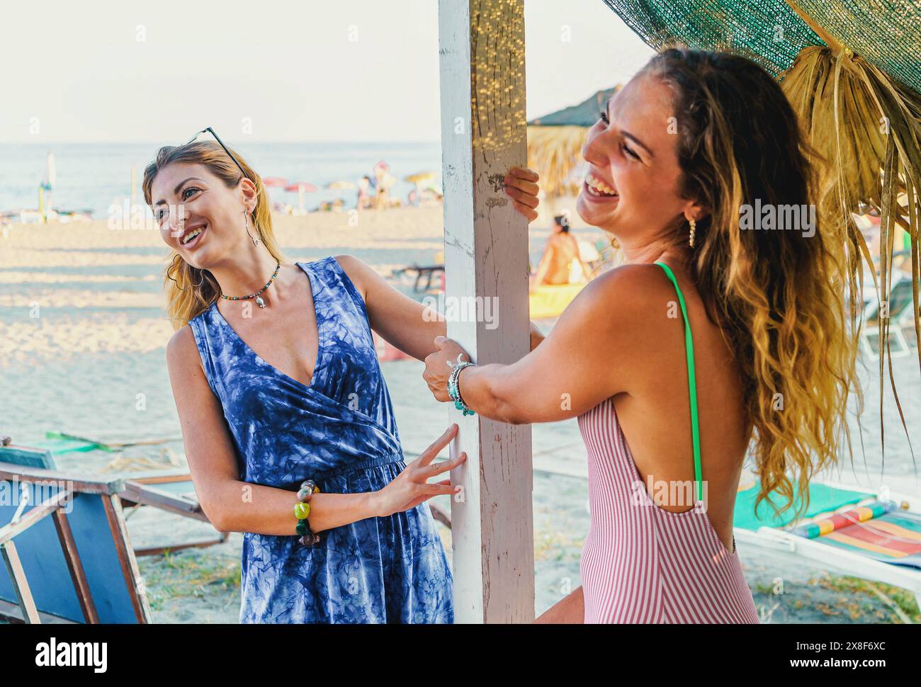 Two women enjoying a day at the beach - laughing and having fun ...