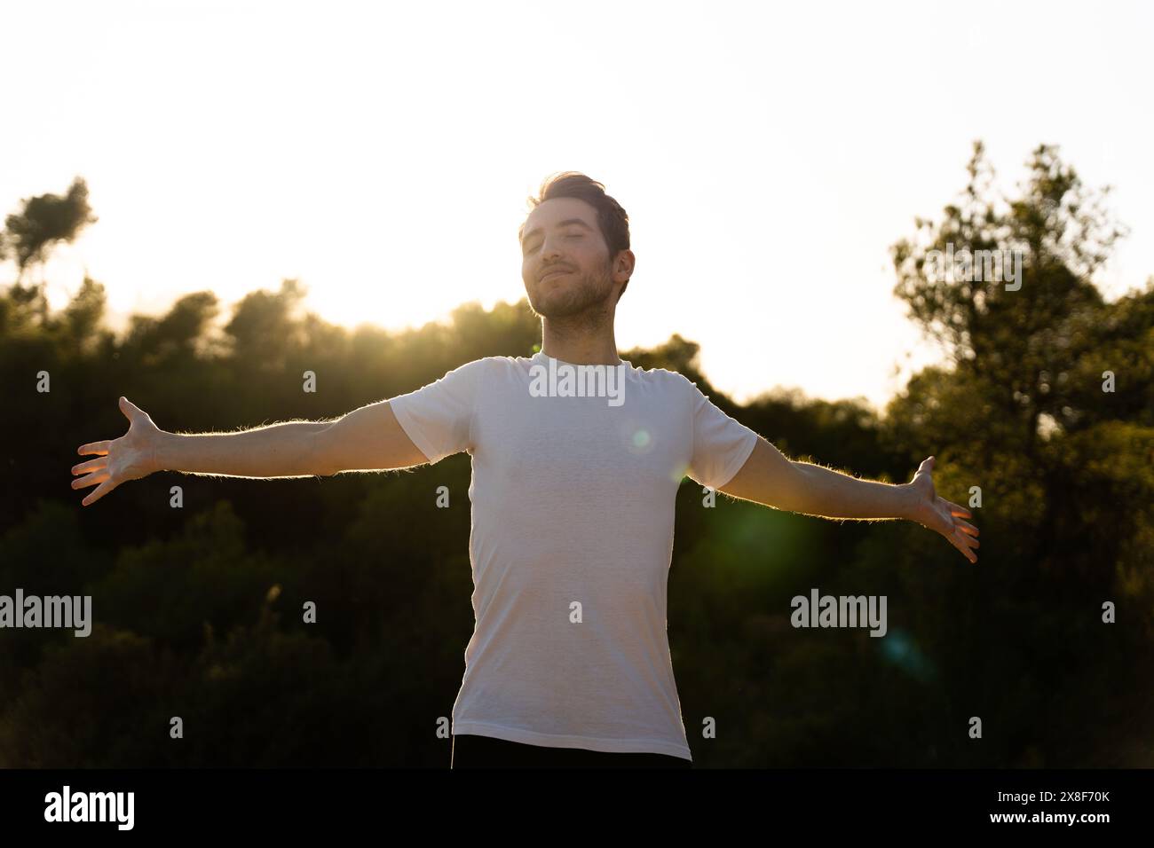 Happy man opens his arms feeling freedom outdoors, feeling of health ...