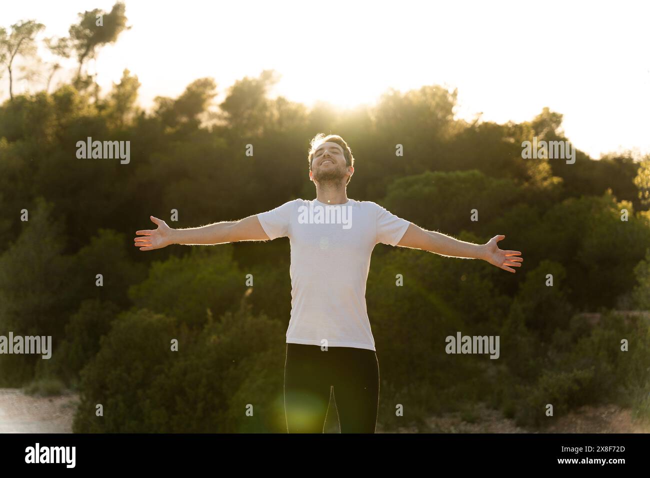 Happy man opens his arms feeling freedom outdoors, feeling of health ...