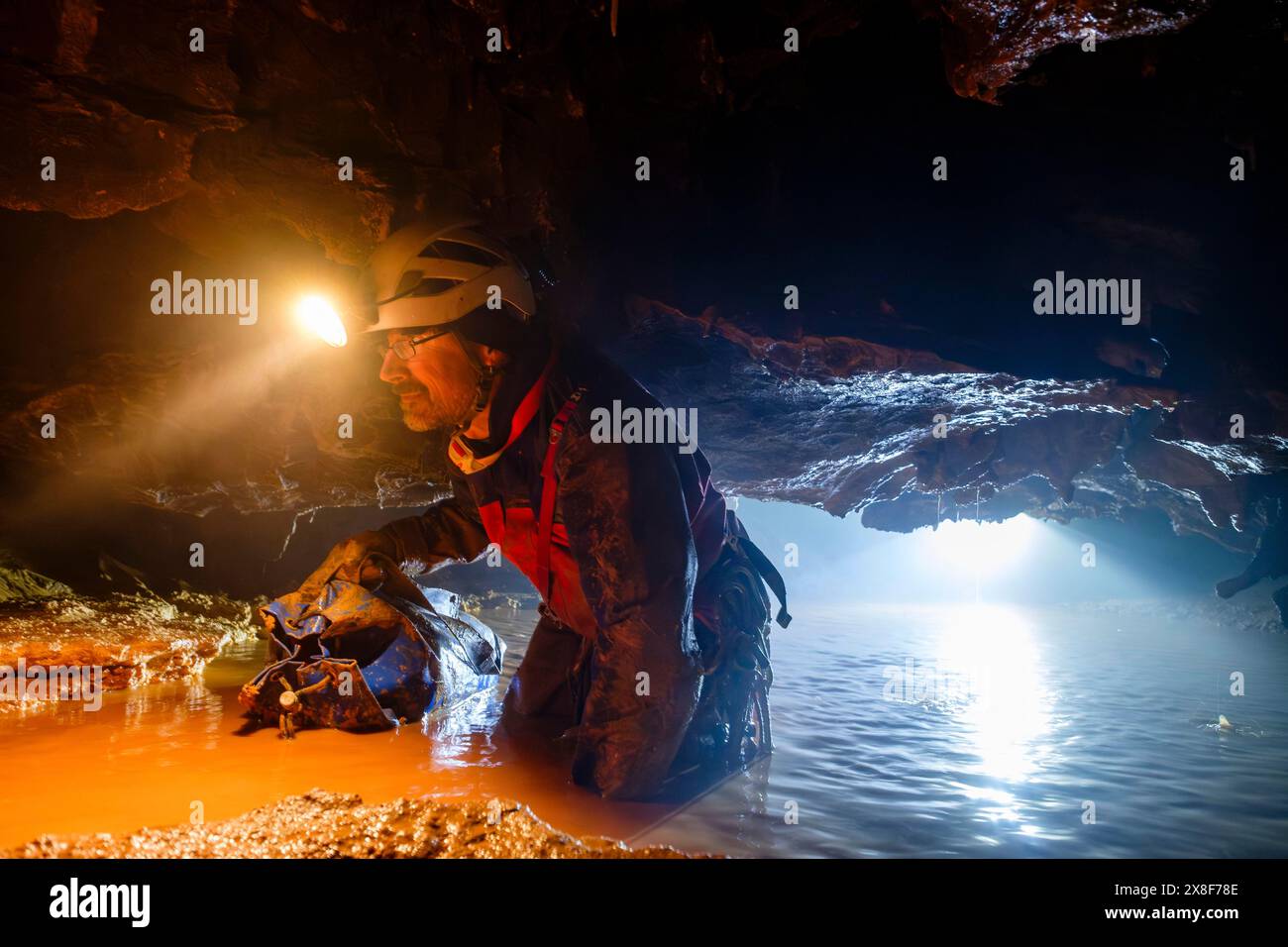 Speleologist crosses an underground lake, Advent Cave, Schneizlreuth ...