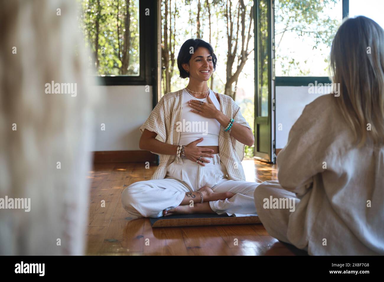 Female yoga coach training group class yoga at breathing meditation ...