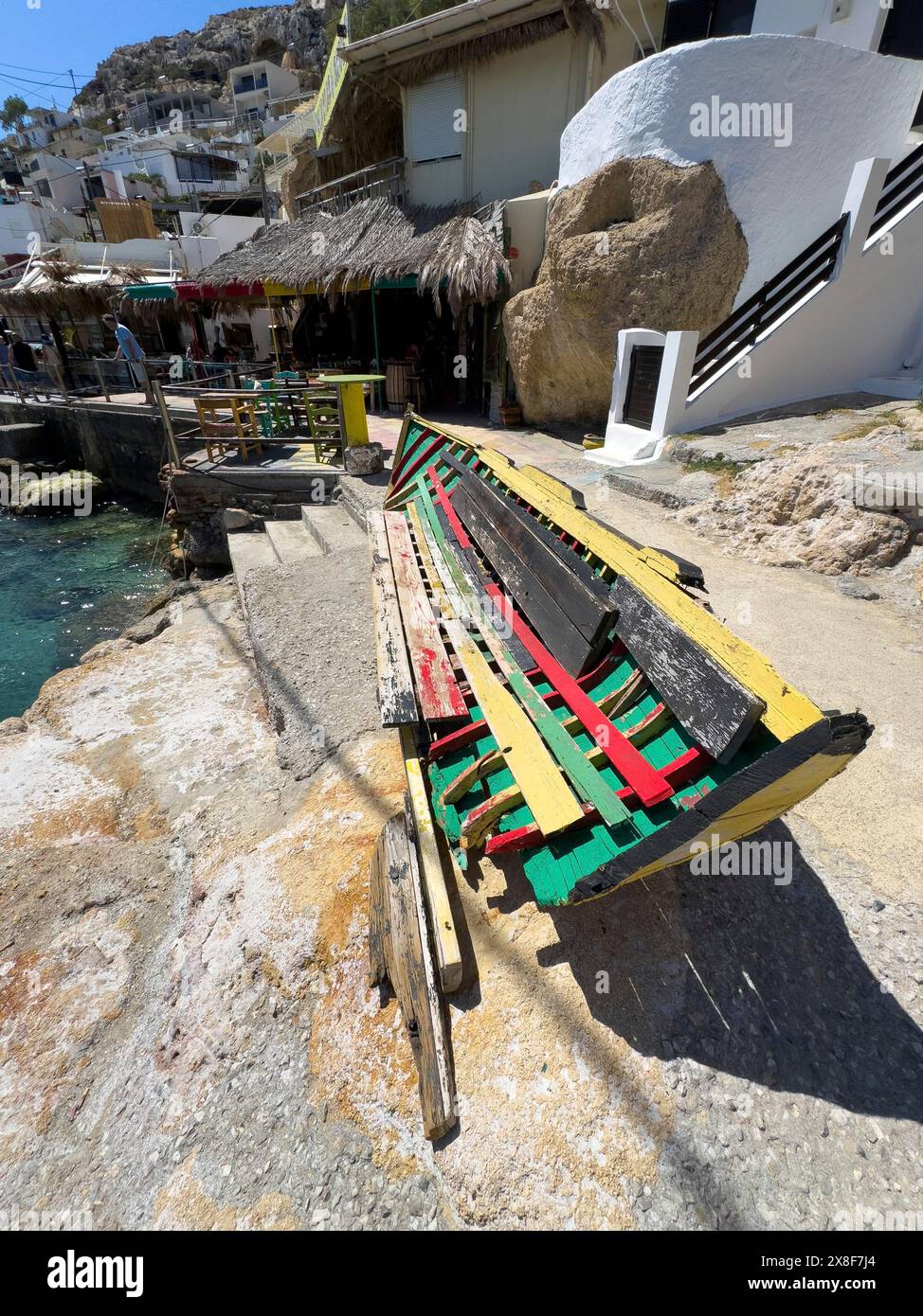 Old painted fishing boat halved and converted into a bench, painted ...