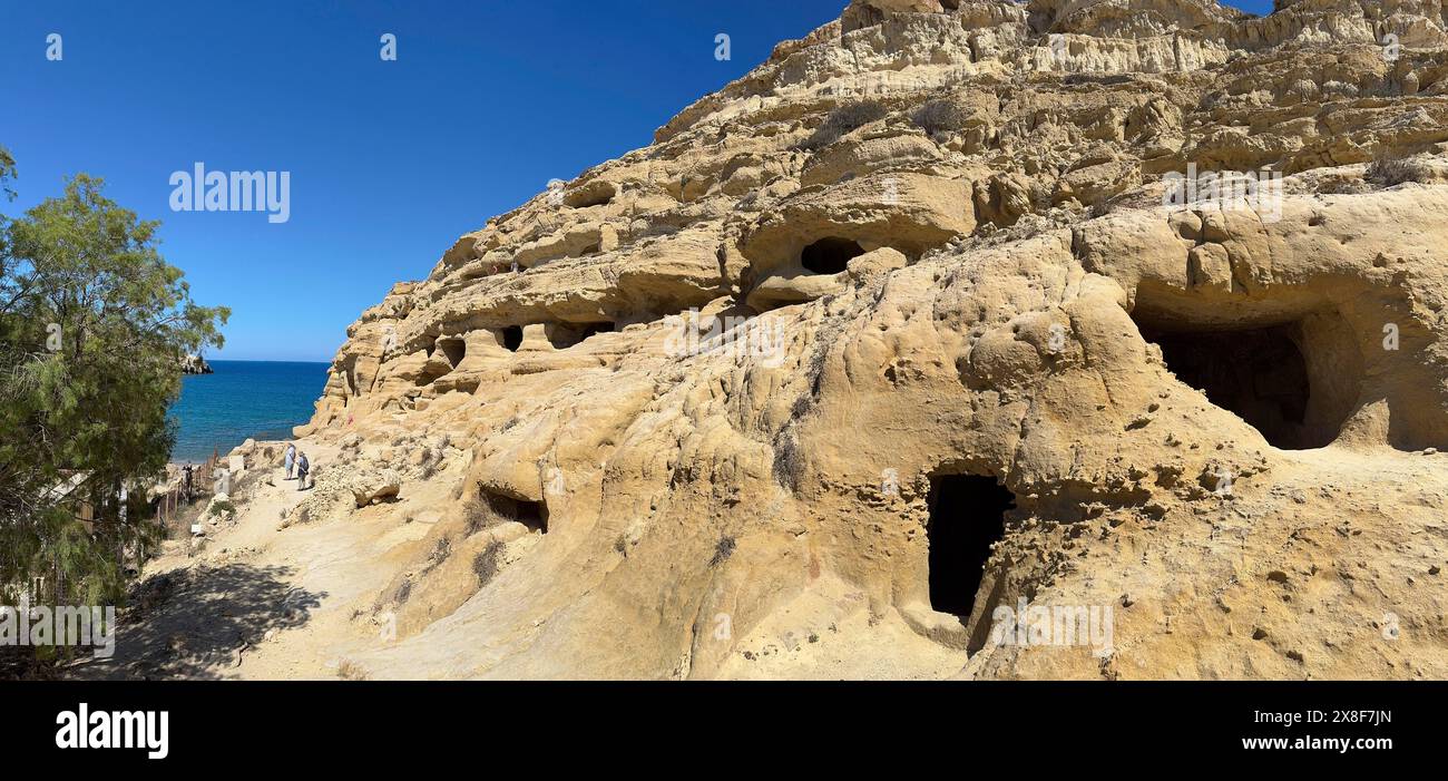 Partial view of former Roman necropolis with cave dwelling tombs carved ...