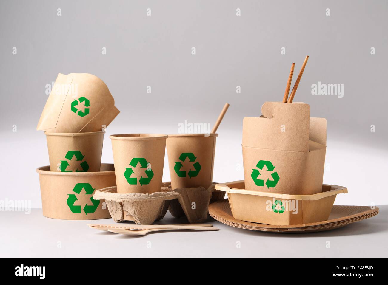 Set of eco friendly food packaging with recycling symbols on light ...