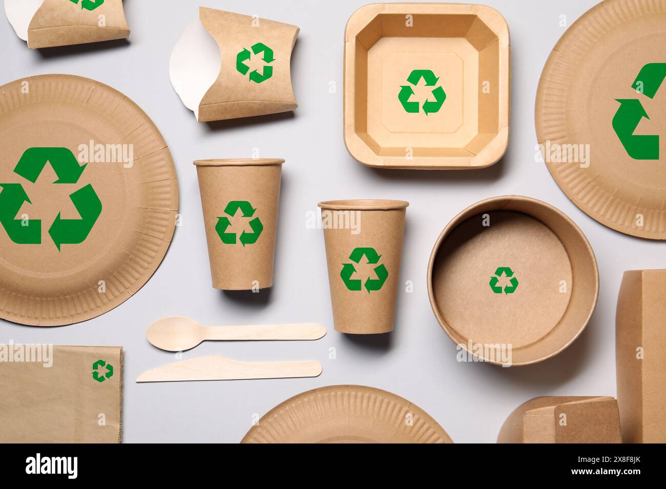 Set of eco friendly food packaging with recycling symbols on light ...