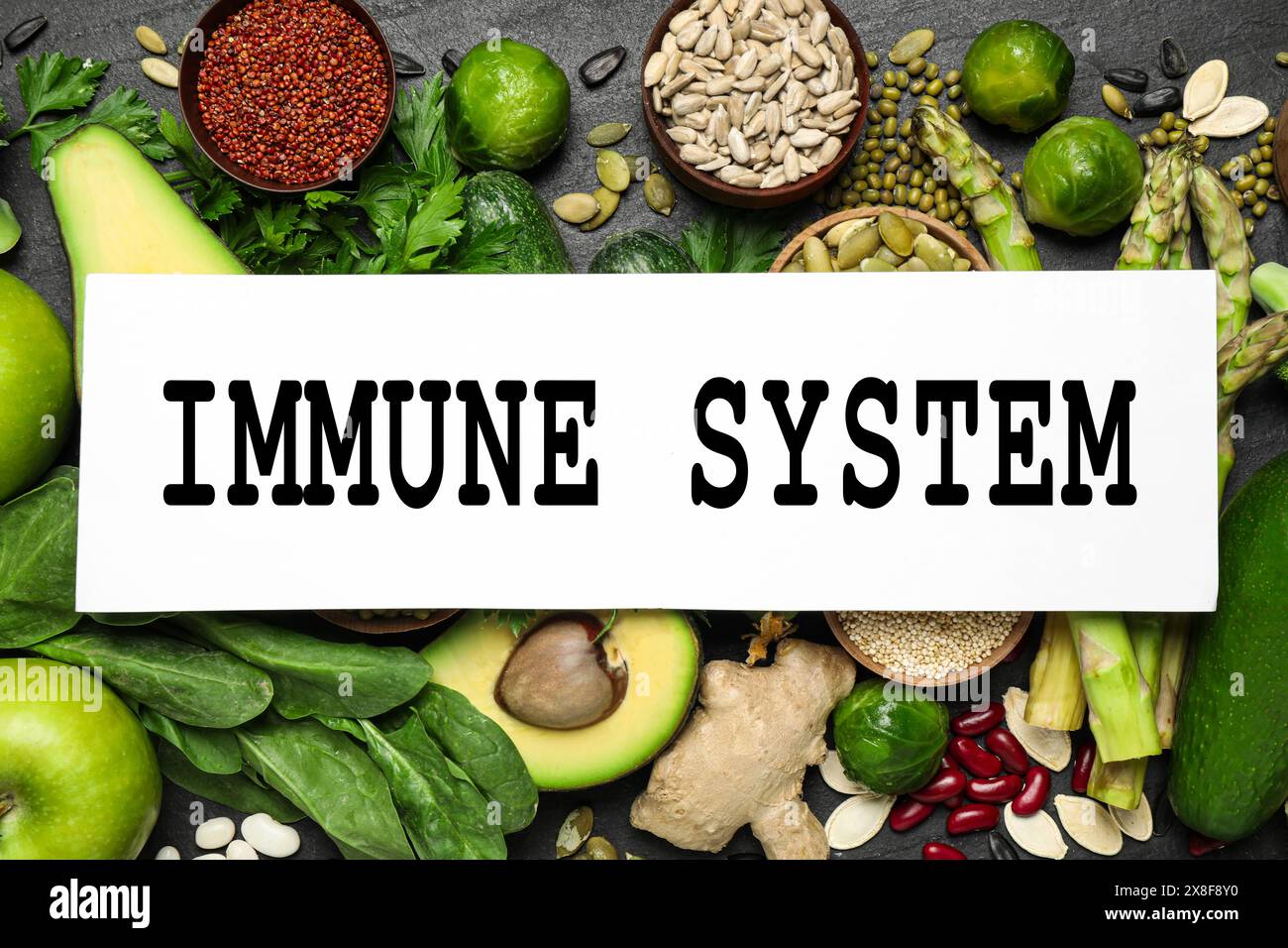 Immune system boosting with proper nutrition. Different foods on black ...