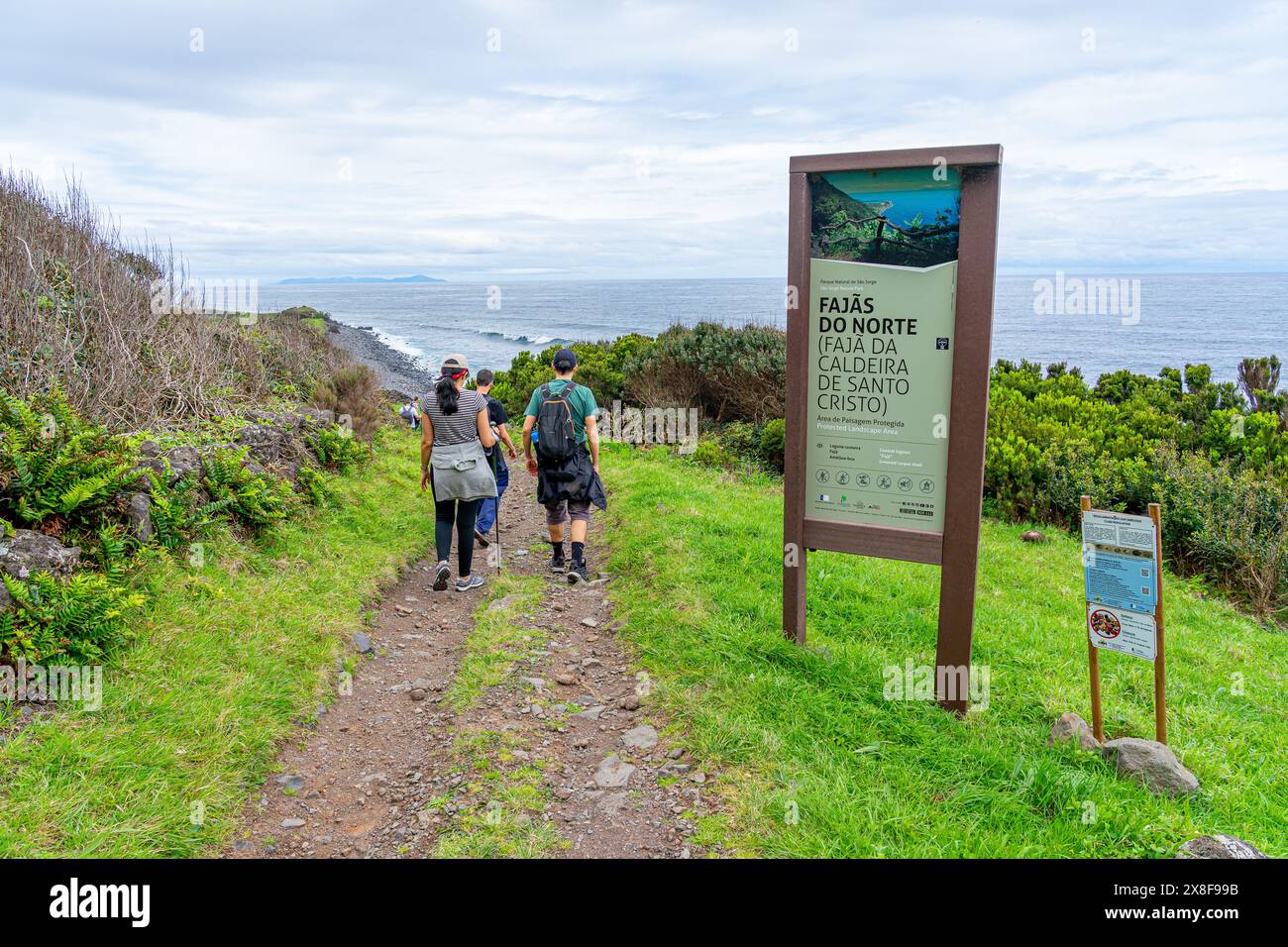 group of hikers arriving at Fajãs in the north of Santo Cristo. São ...