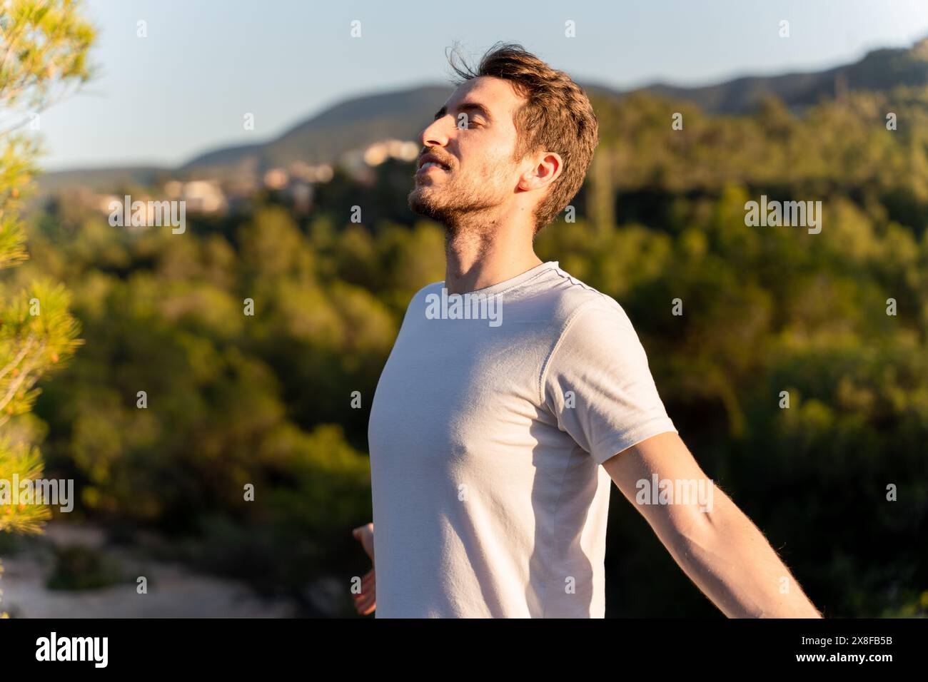 Portrait of a smiling man breathing fresh air from nature. Mental and ...