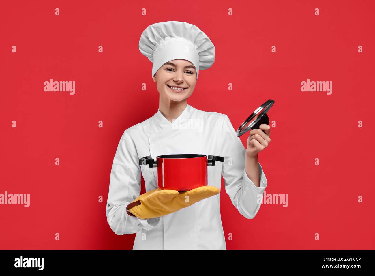 Professional chef with cooking pot on red background Stock Photo - Alamy