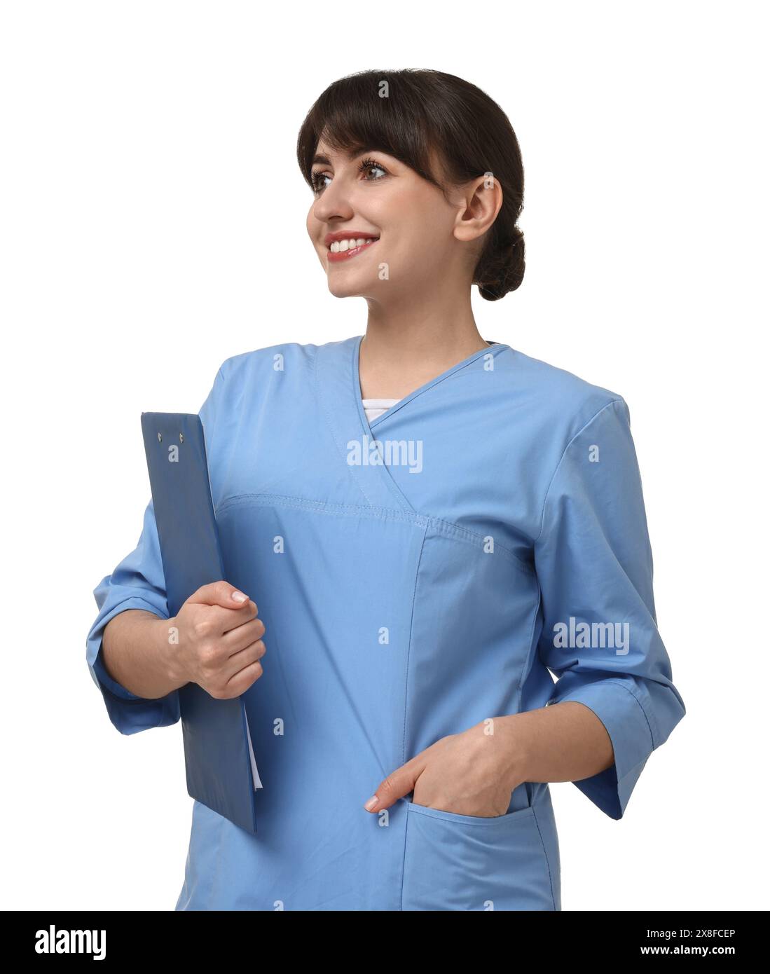 Portrait of smiling medical assistant with clipboard on white ...