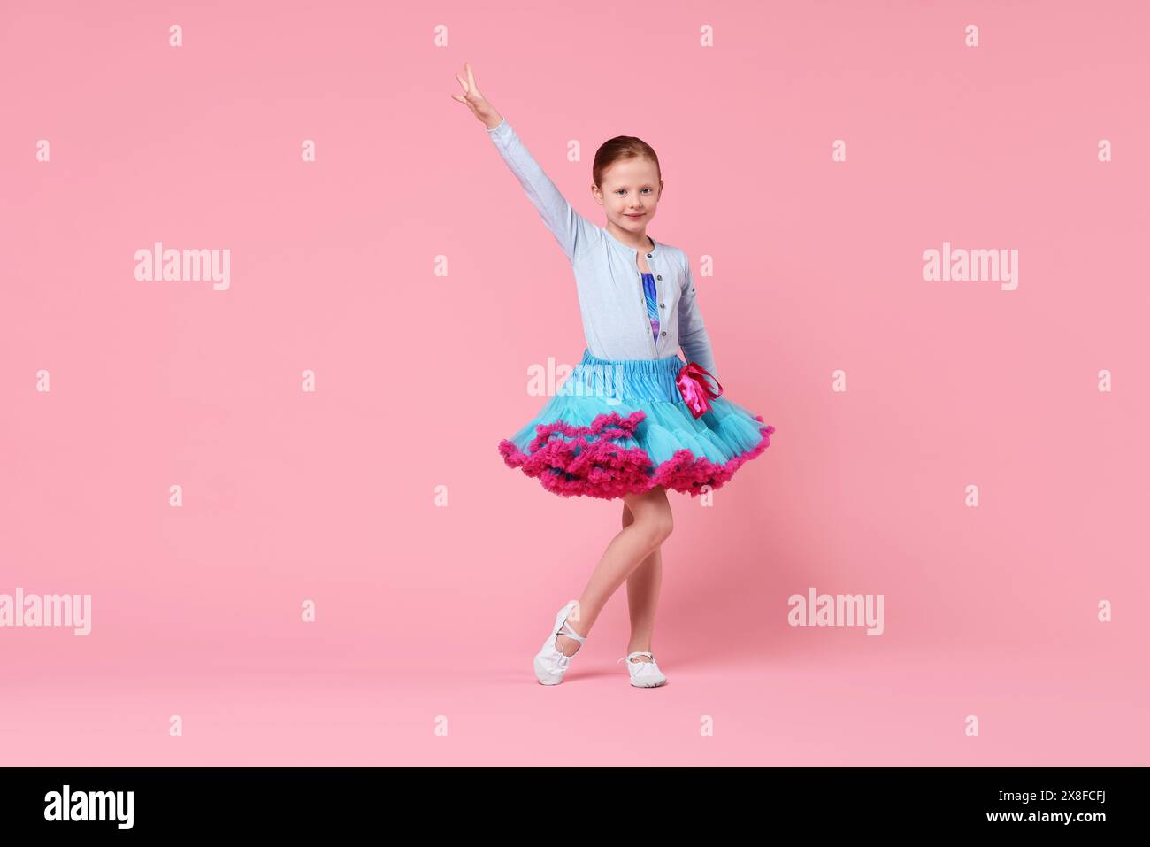 Cute little girl dancing on pink background Stock Photo - Alamy