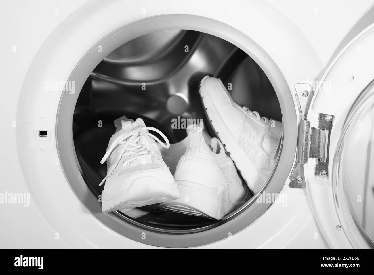 Stylish clean sneakers inside modern washing machine Stock Photo - Alamy