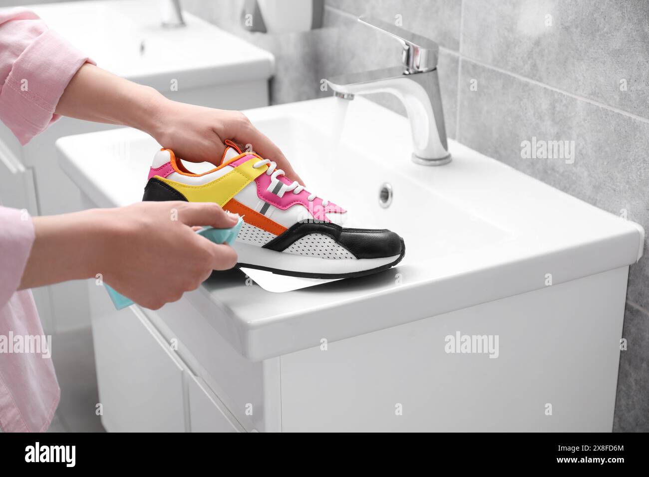 Woman washing stylish sneakers with brush in sink, closeup Stock Photo ...