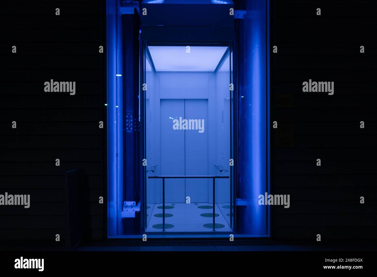 Modern illuminated elevator with blue lighting Stock Photo - Alamy