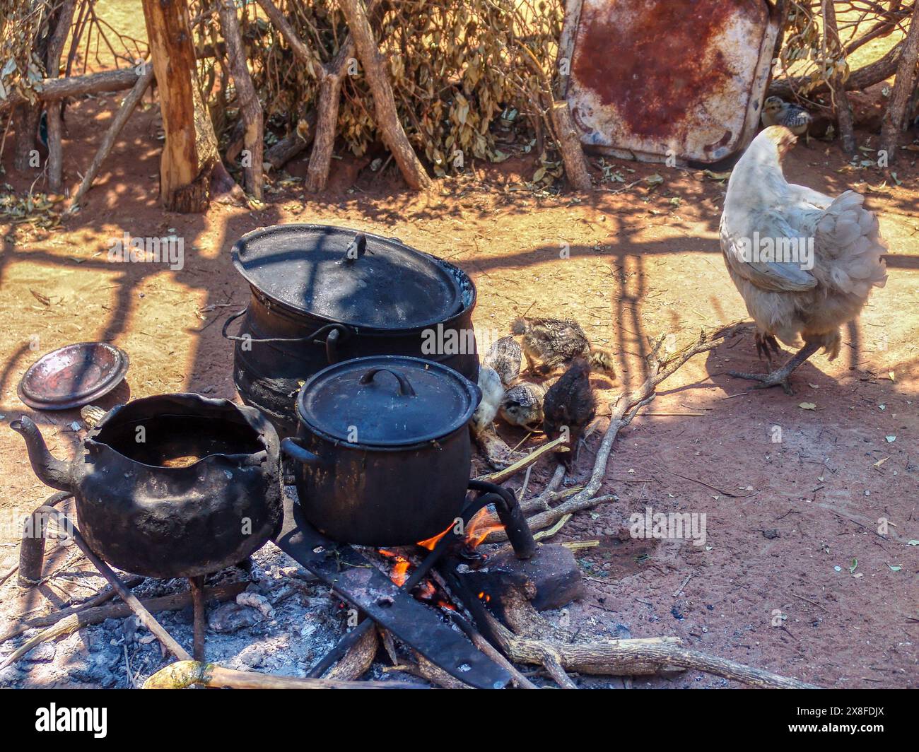 village traditional african outdoors kitchen, three legged cast iron ...