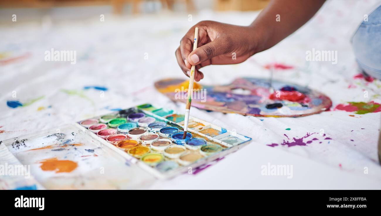 Mixing paint, hand and paintbrush with colors for art, picture and ...