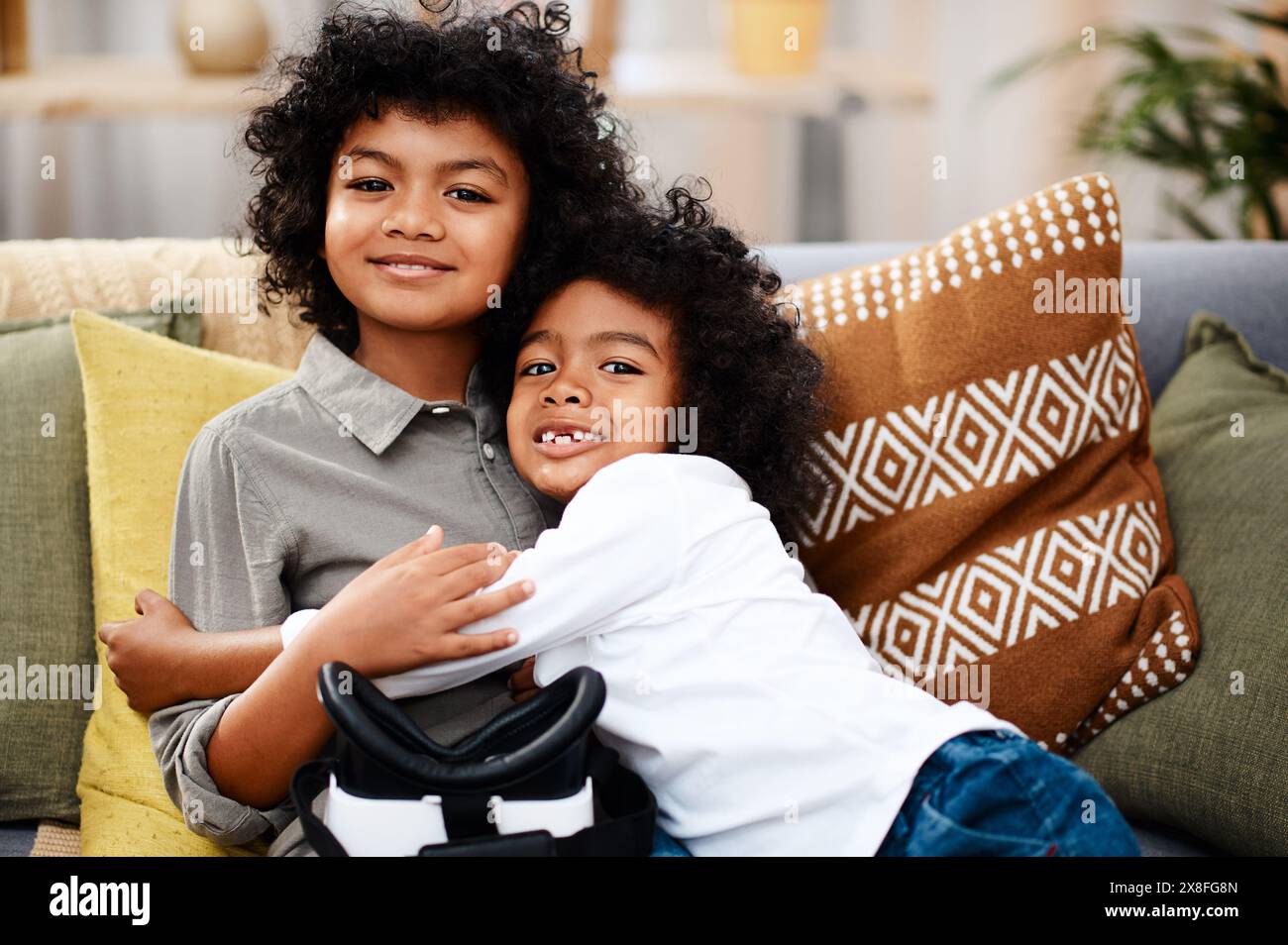 Hugging, couch and brothers in living room for portrait, support and ...