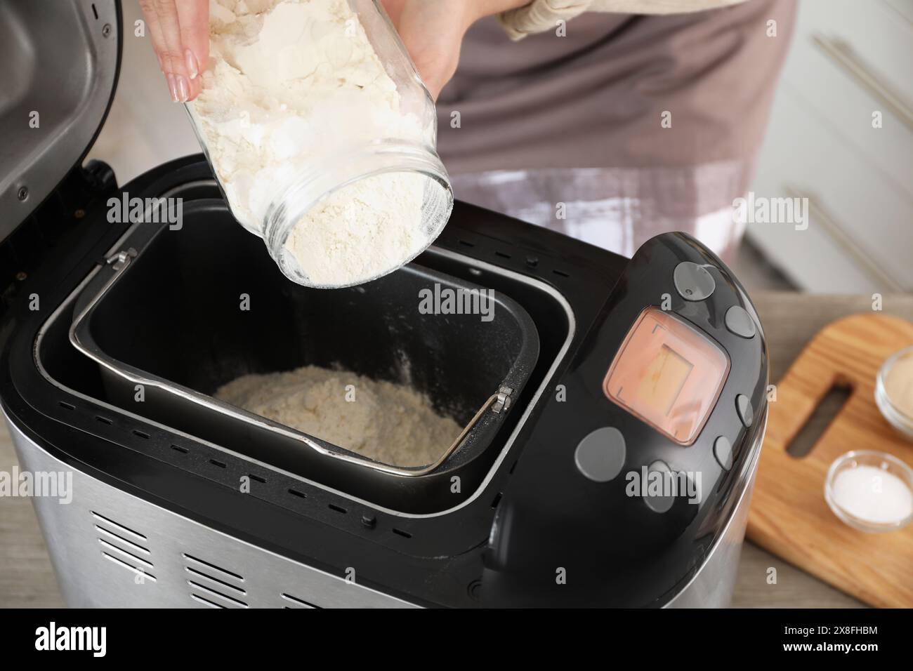 Making dough. Woman adding flour into breadmaker machine, closeup Stock ...