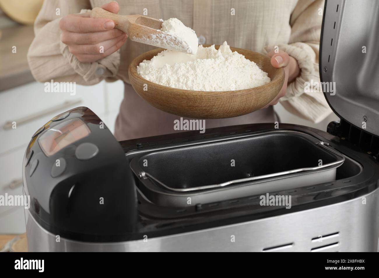 Making dough. Woman adding flour into breadmaker machine, closeup Stock ...